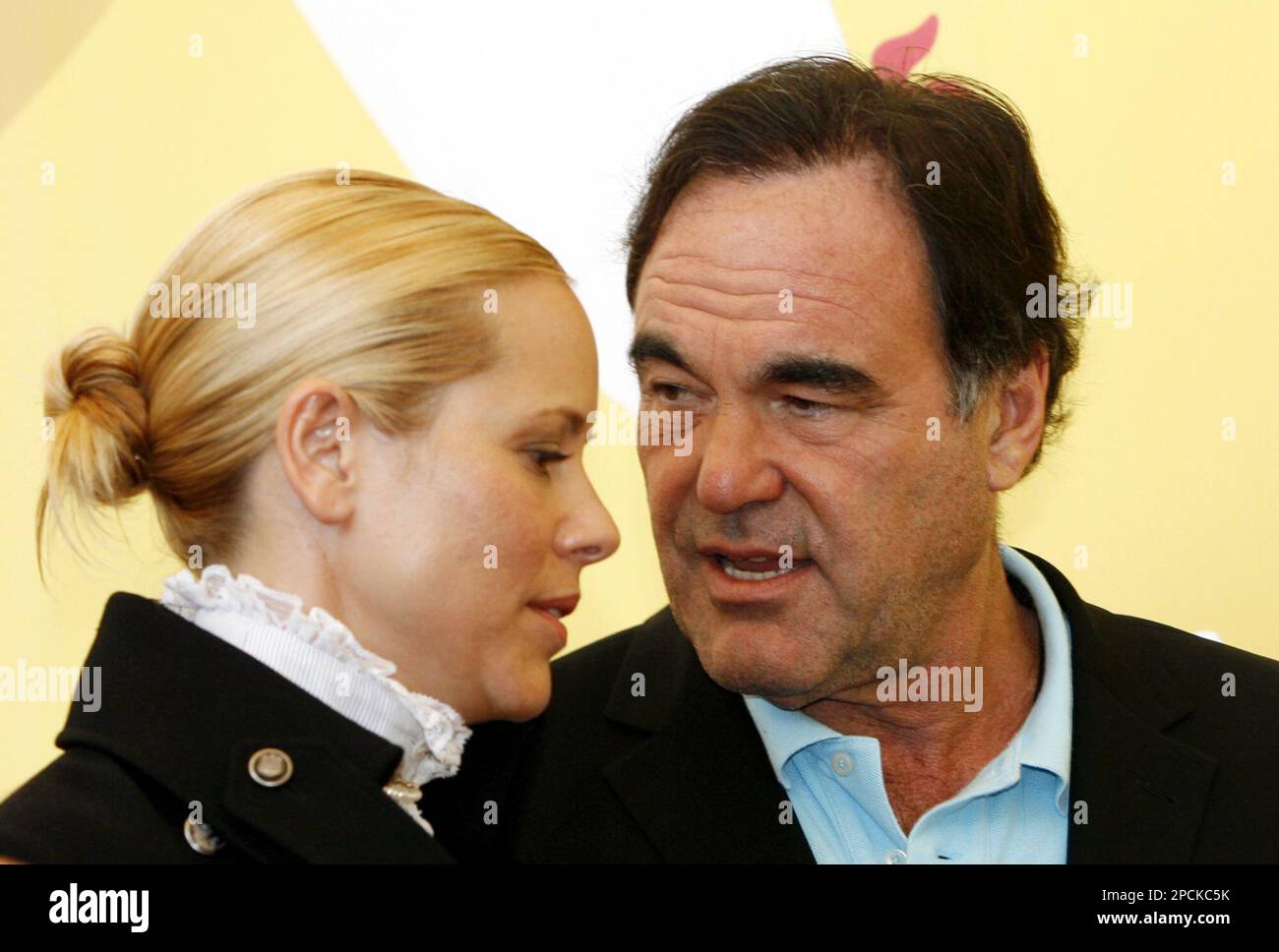 U.S. director Oliver Stone, right, and U.S. actress Maria Bello share a ...