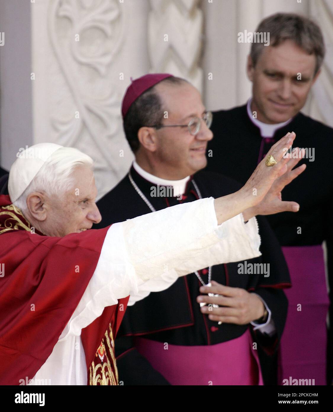 Pope Benedict XVI, left, greets the faithful next to Bishop Bruno Forte ...