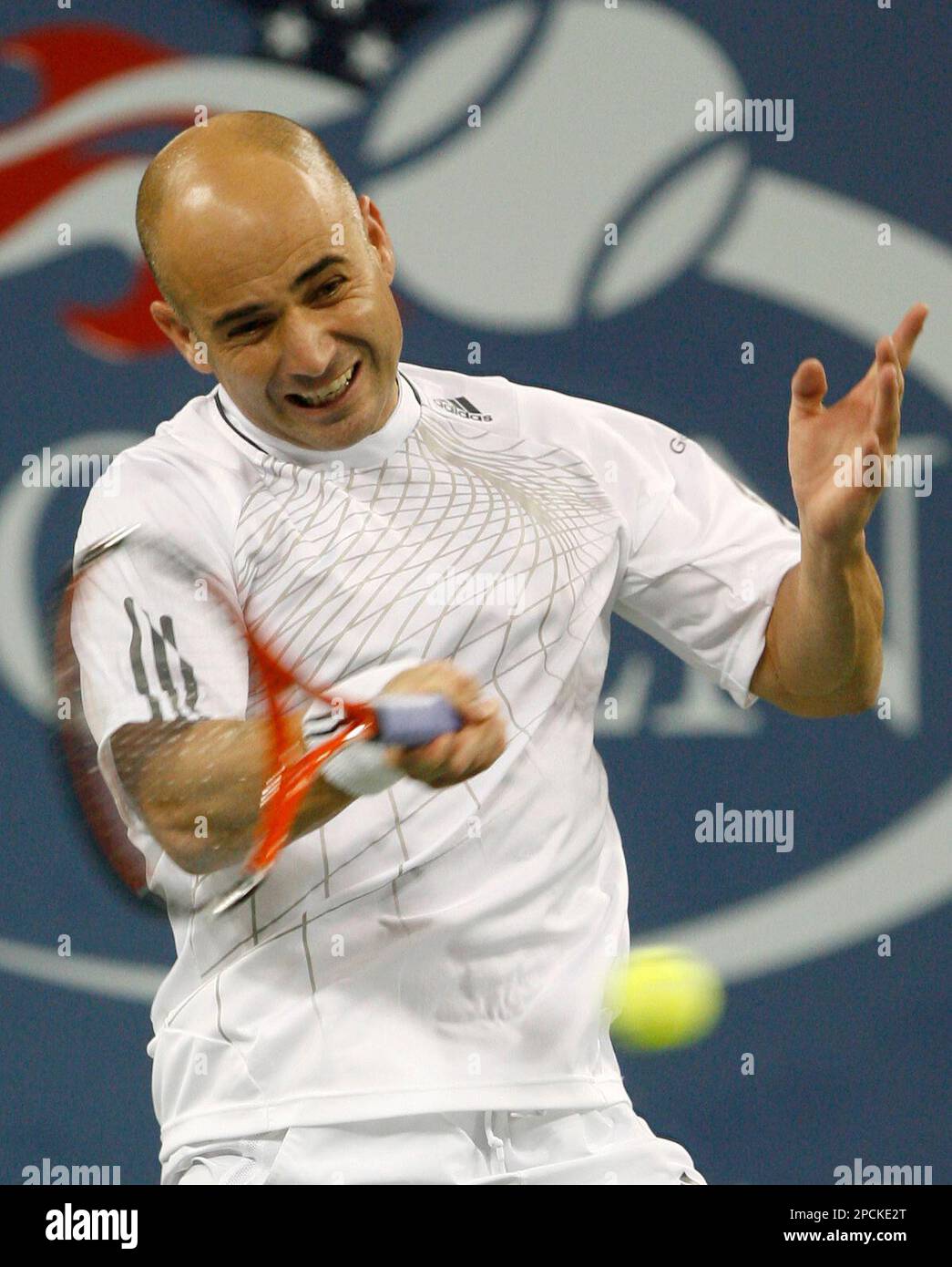 Andre Agassi, of the United States, hits a return to Marcos Baghdatis ...