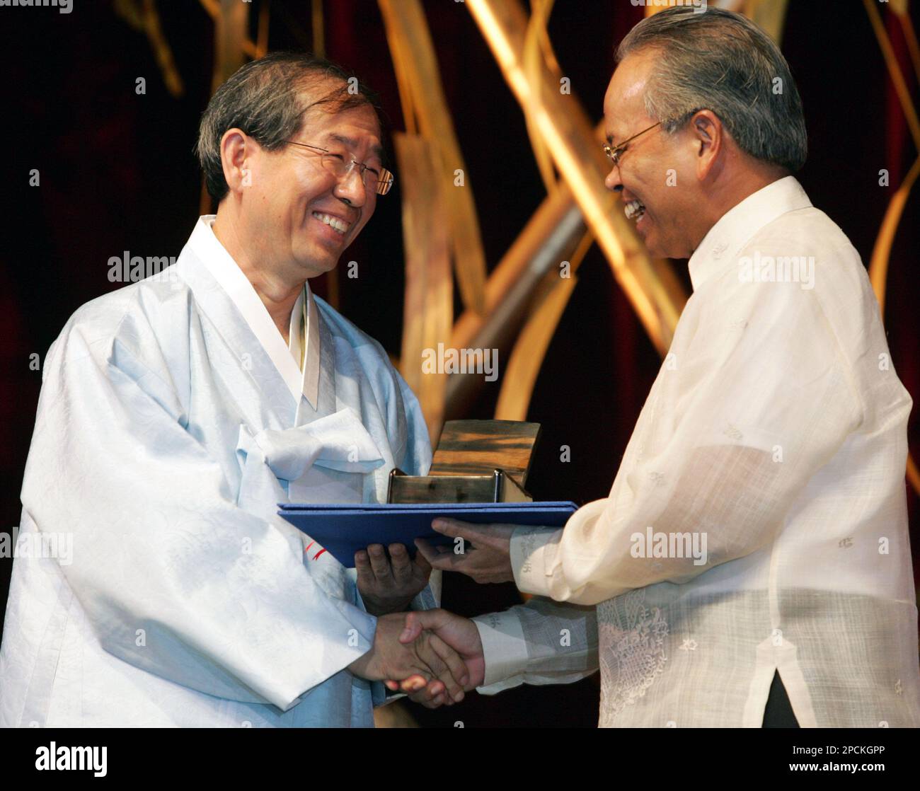 Park Won-soon, left, of South Korea, beams as he receives the Ramon ...