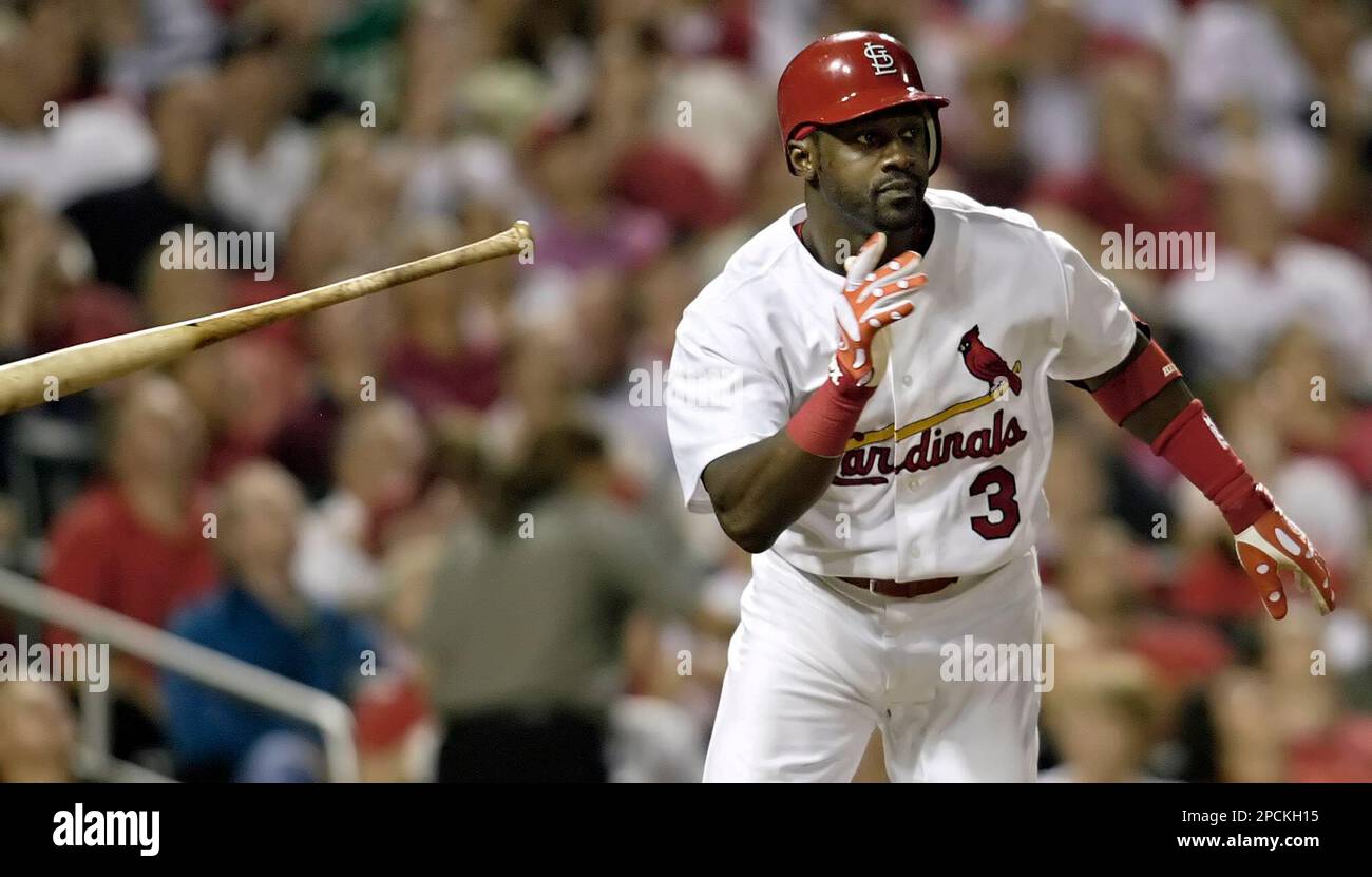 St. Louis Cardinals' Preston Wilson tosses his bat after hitting an RBI ...