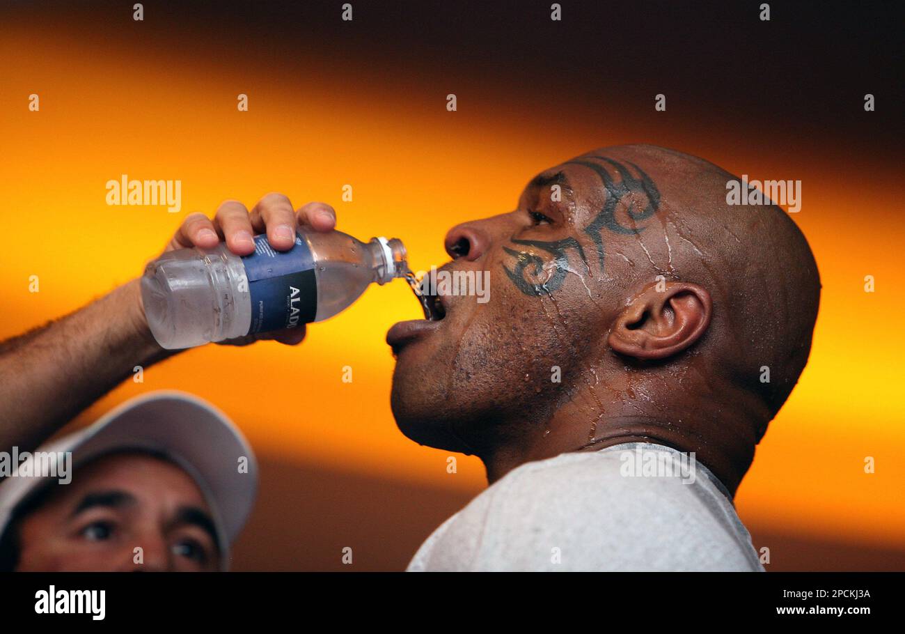 Former heavyweight boxing champion Mike Tyson gets a drink of water ...