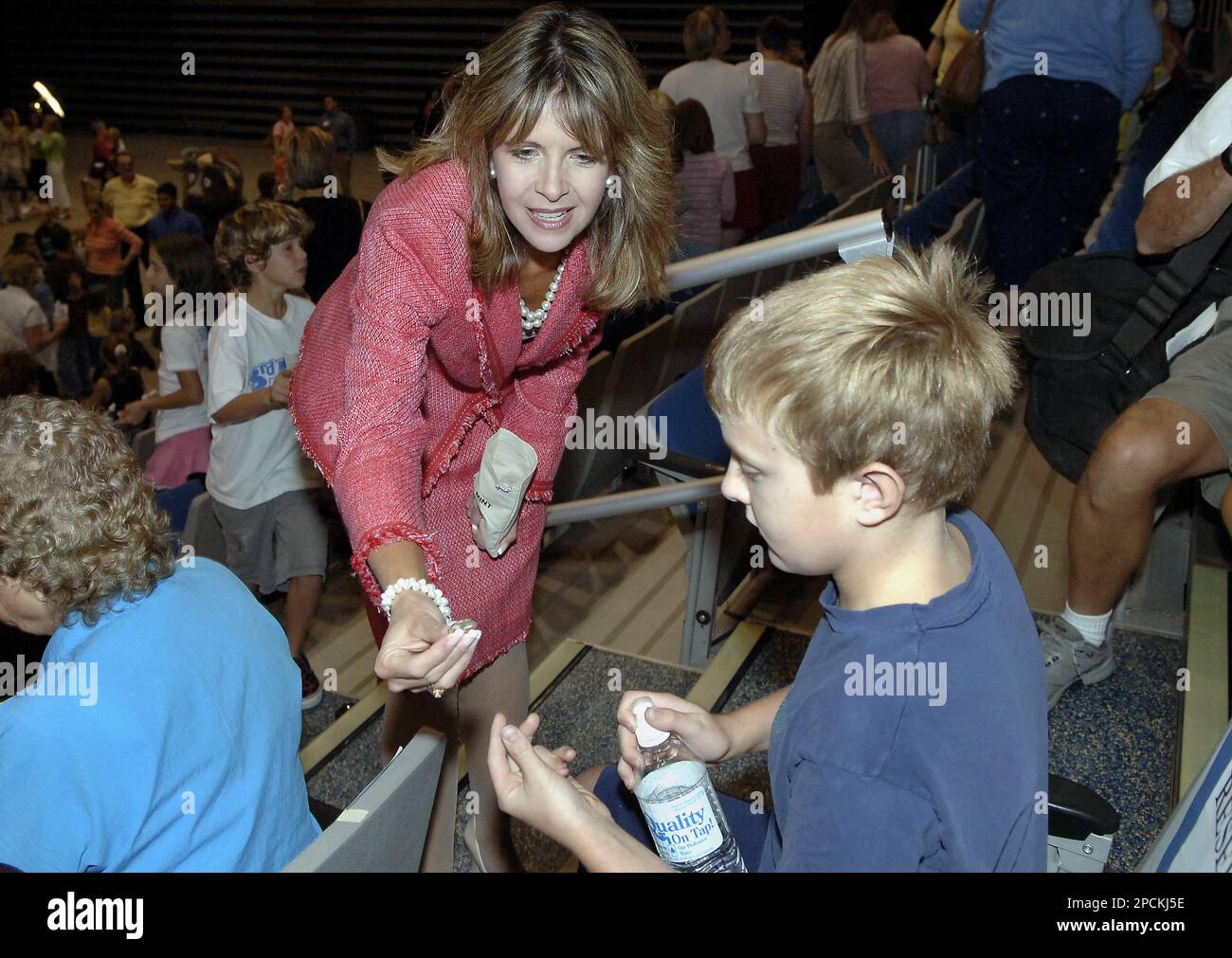 North Dakota first lady Mical Mikey Hoeven, center, passes out the new ...
