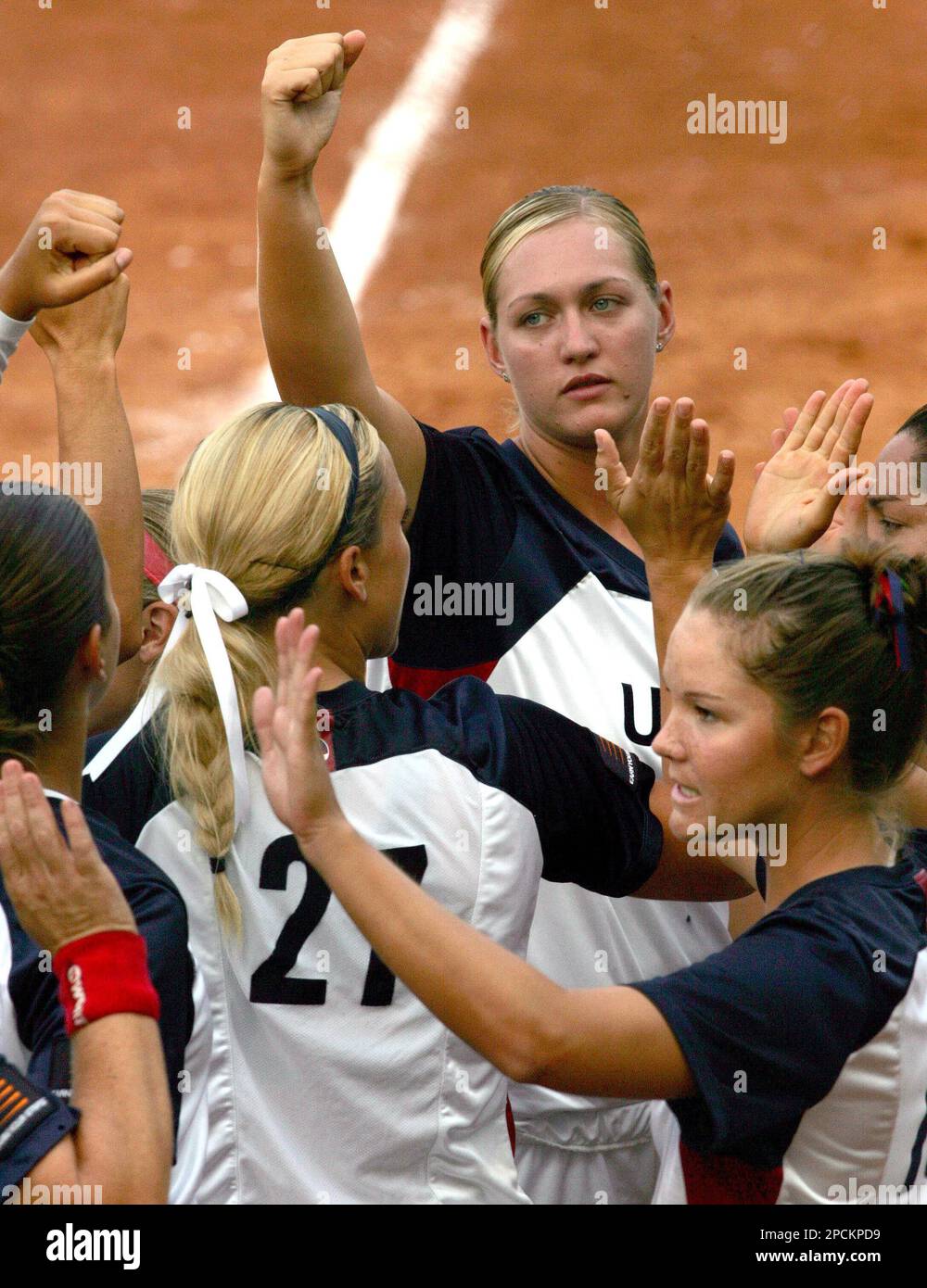 U.S. women's softball team members celebrate their 4-0 win over Canada ...