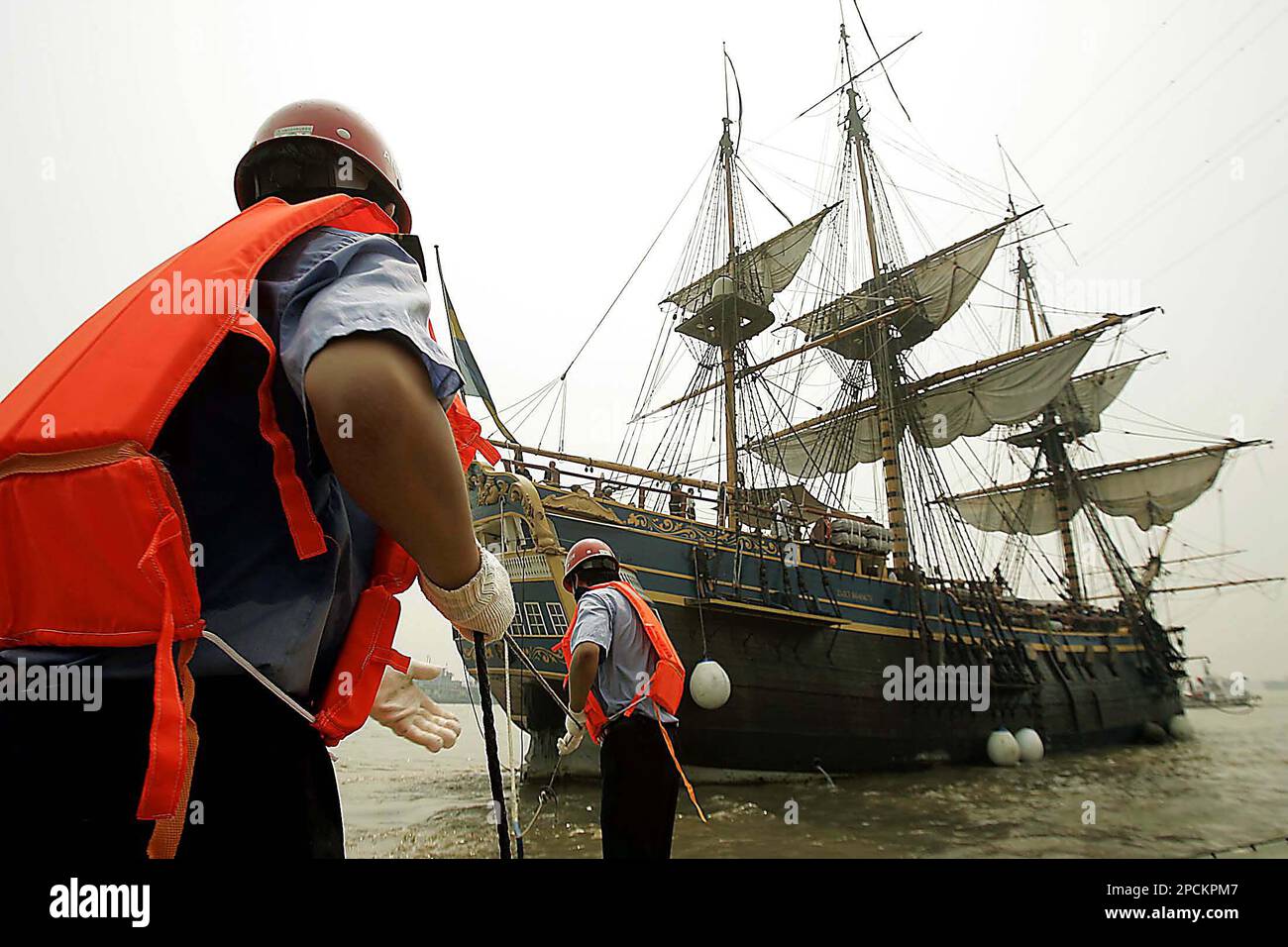 Port officials help the Swedish Ship "Gotheborg, " a replica of a ship ...
