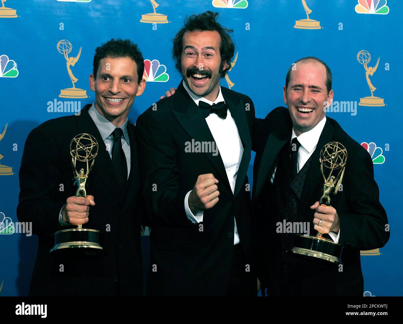 Actor Jason Lee, center, joins Greg Garcia, right, holding the award ...