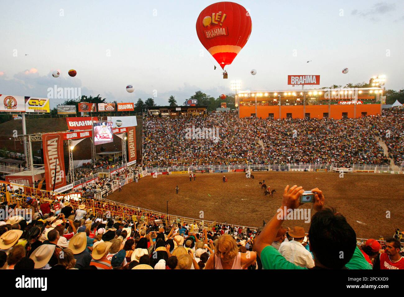 People watch the rodeo as a balloon passes by at the Barretos Rodeo ...