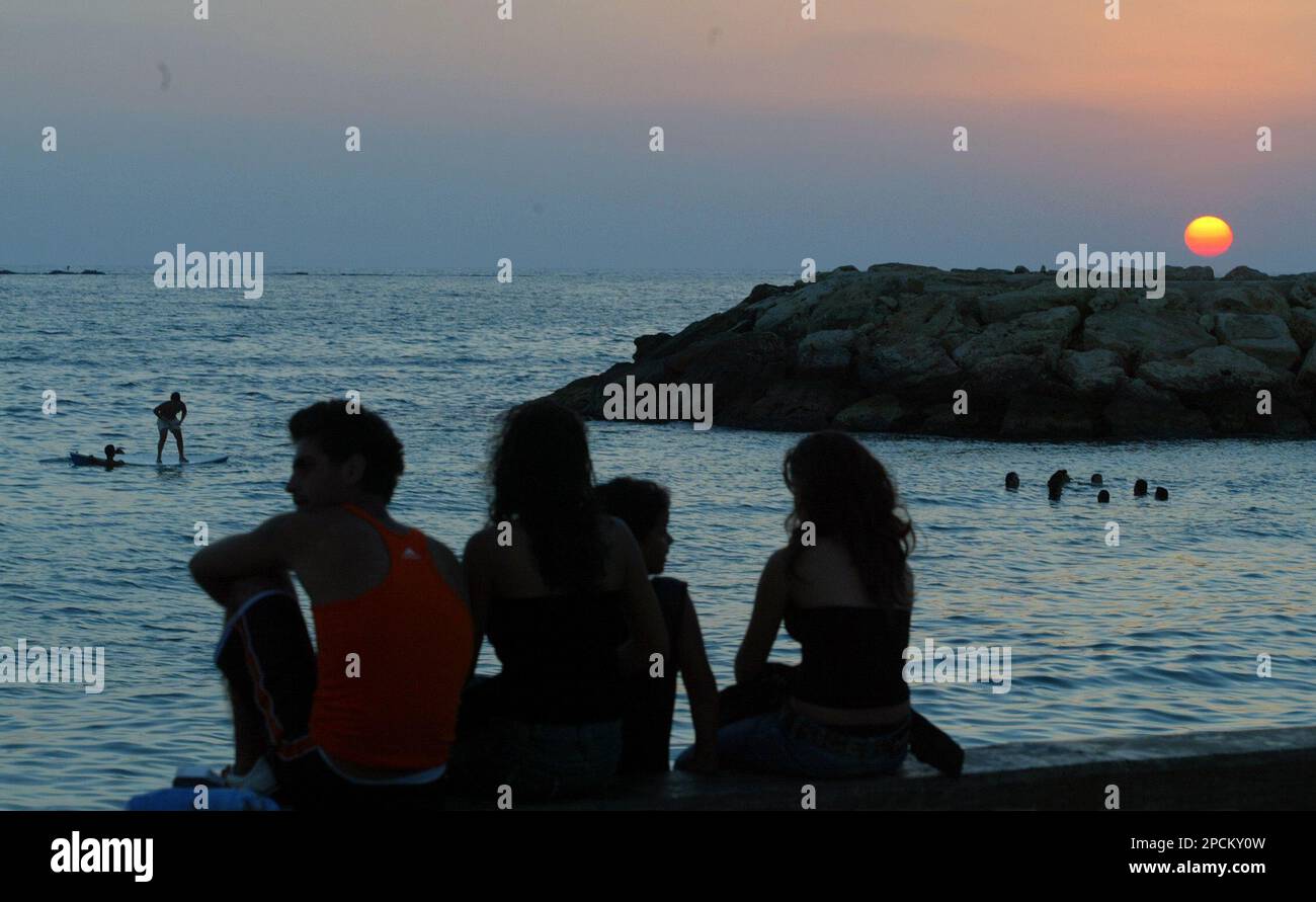 Lebanese enjoy sunset and warm water of the Mediterranean Sea in the ...