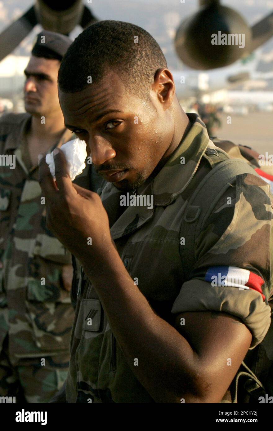 A French Legionnaire wipes his brow after arriving on a military ...