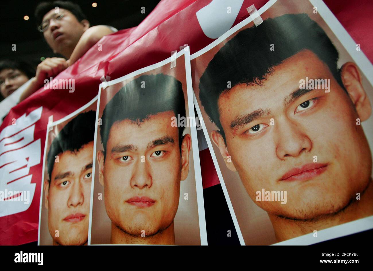 Chinese basketball fans display their super star Yao Ming's portraits ...