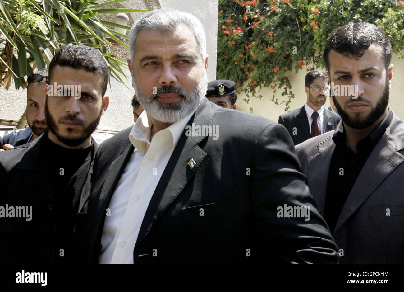 Palestinian Prime Minister Ismail Haniyeh, from Hamas, center, escorted ...
