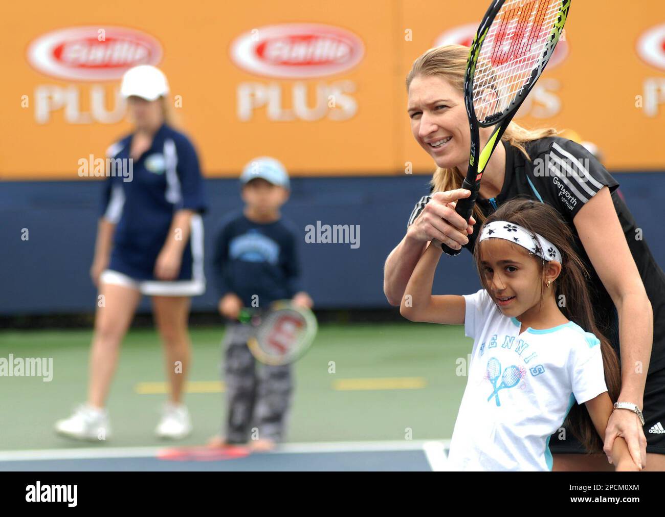 Tennis great Steffi Graf, right, instructs Jessica Bellomo of Glenncove ...
