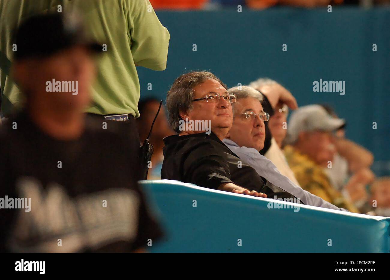 Florida Marlins owner Jeffrey Loria (dark shirt) watches the ball game ...