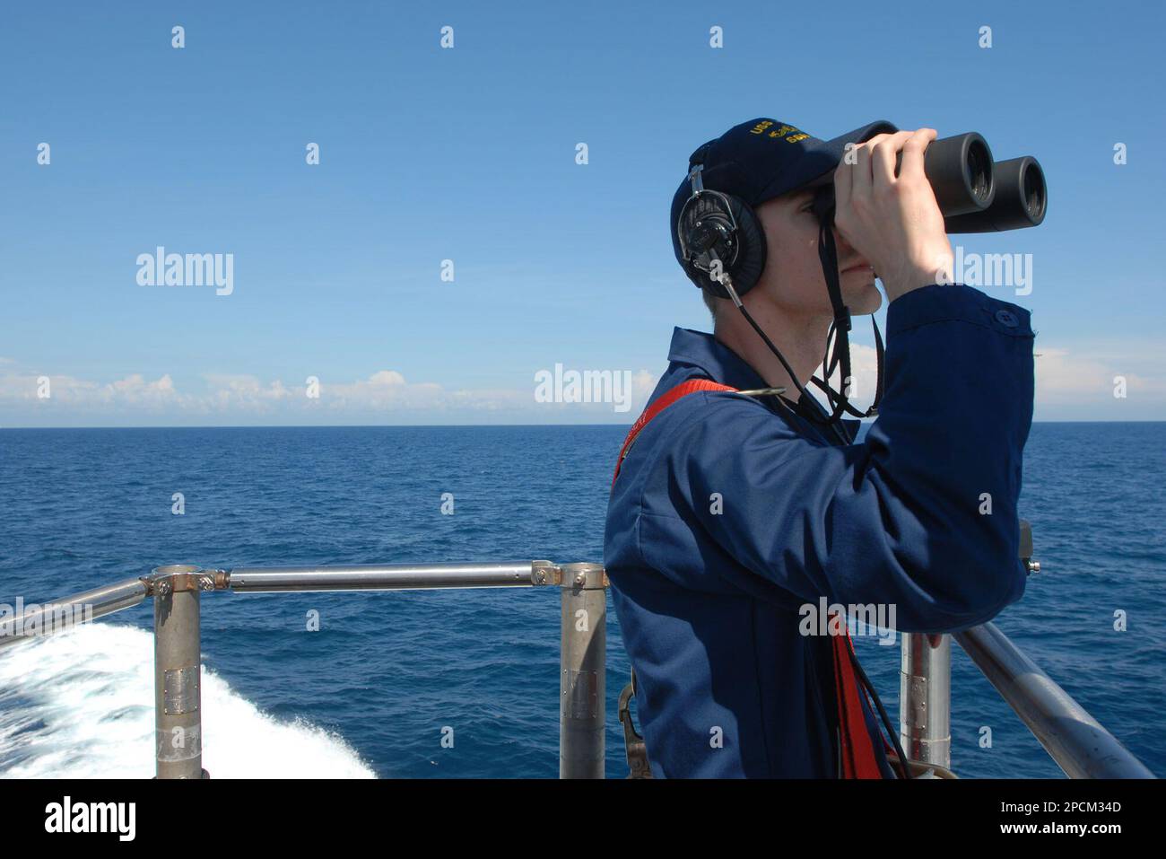 Navy Lt. j.g. Christopher Wing scans the horizon in his lookout ...