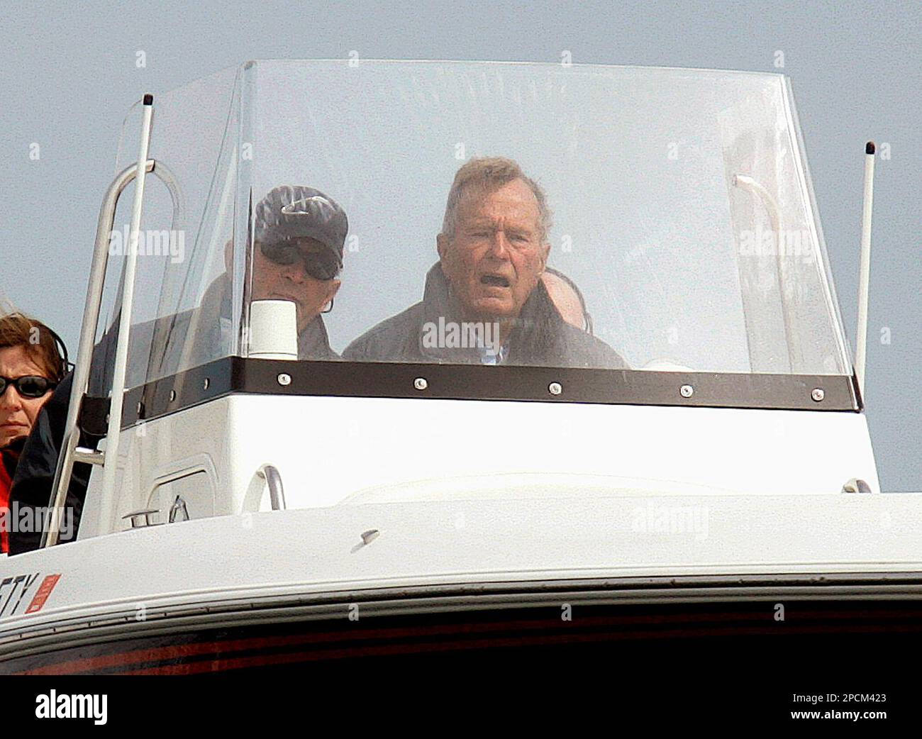 President George W. Bush, left, rides with his father, former President ...