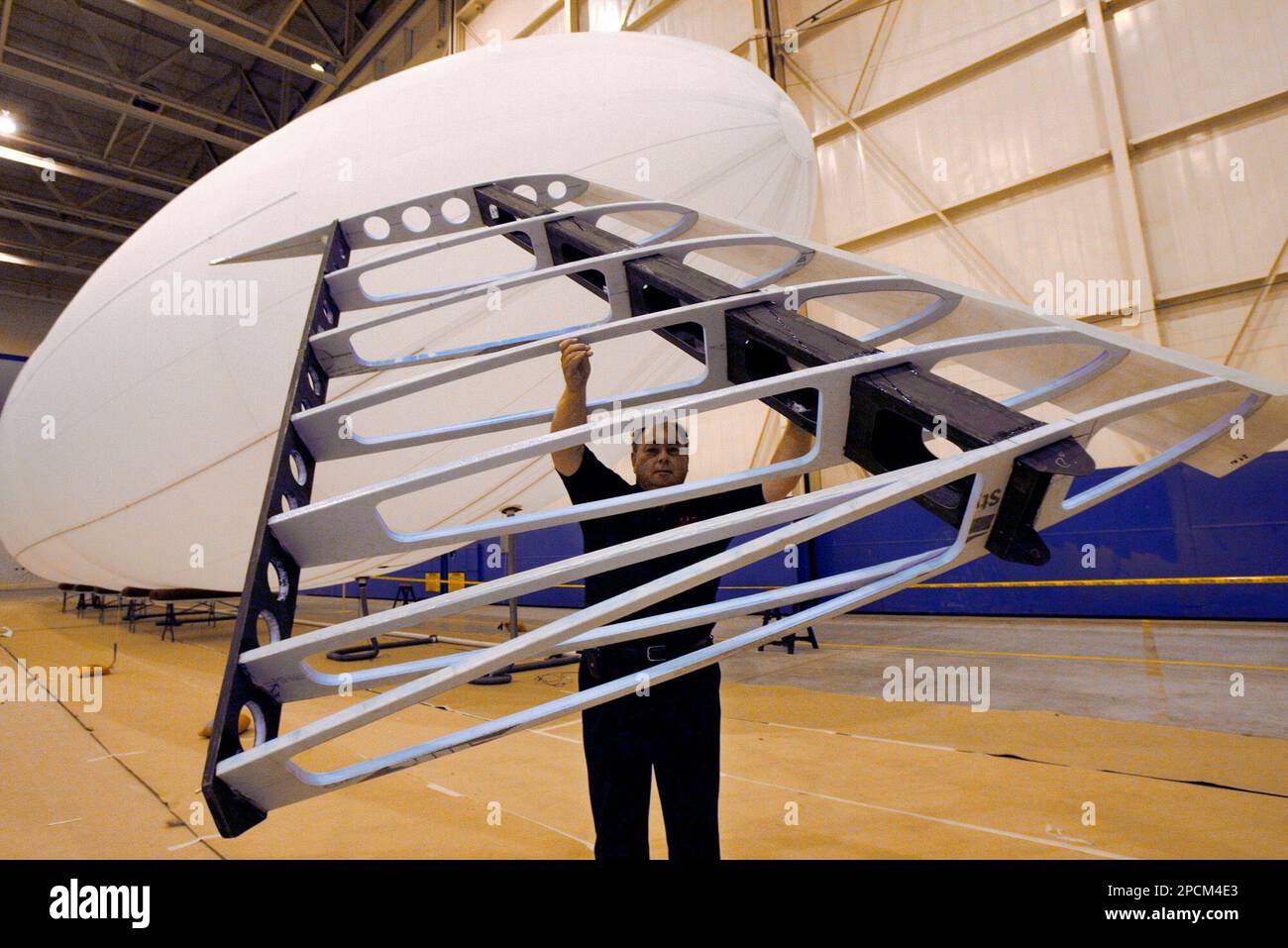 Bob Jones, president of Sanswire Networks, holds a fin made of carbon ...
