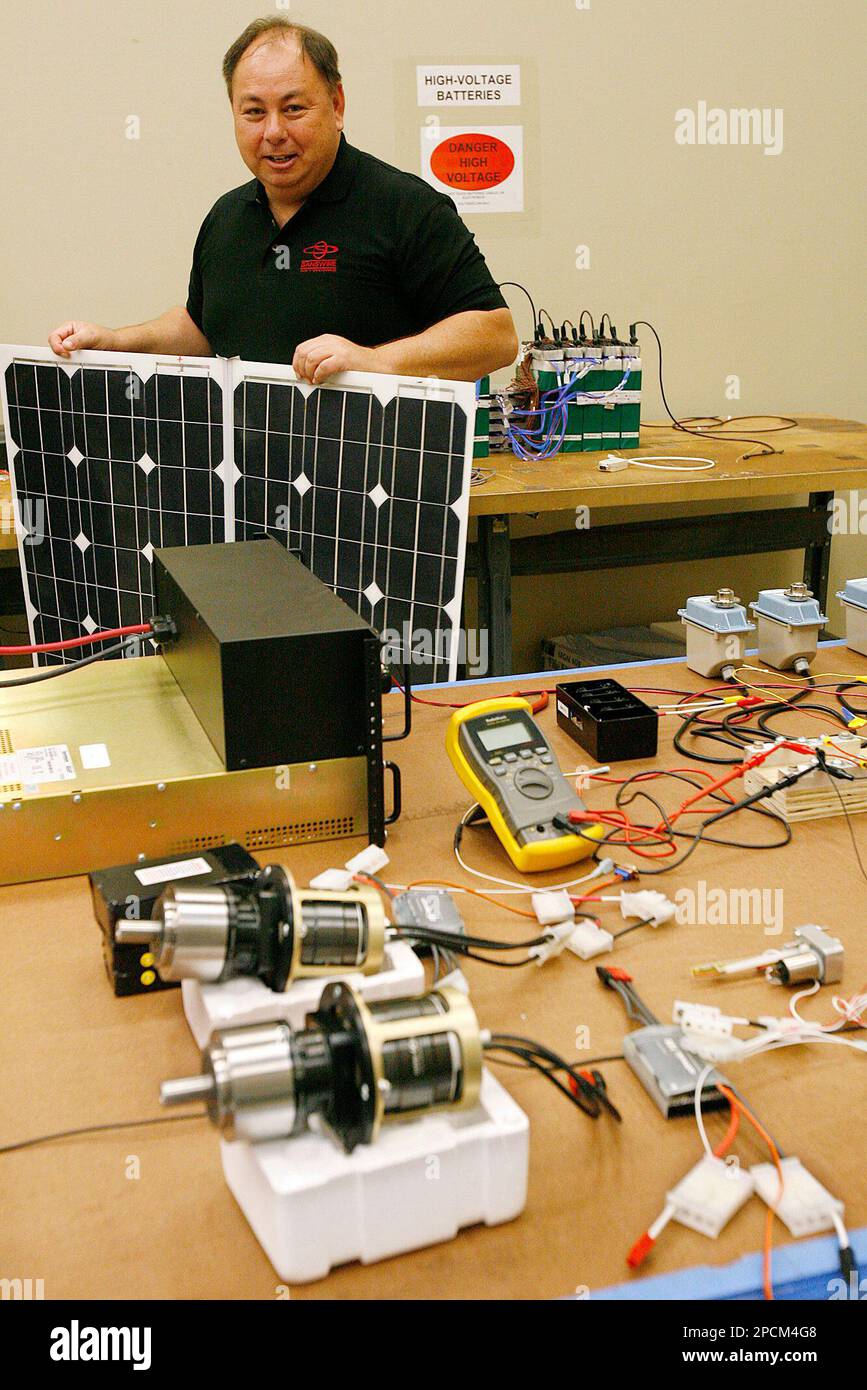 Bob Jones, president of Sanswire Networks, displays a solar cell for ...