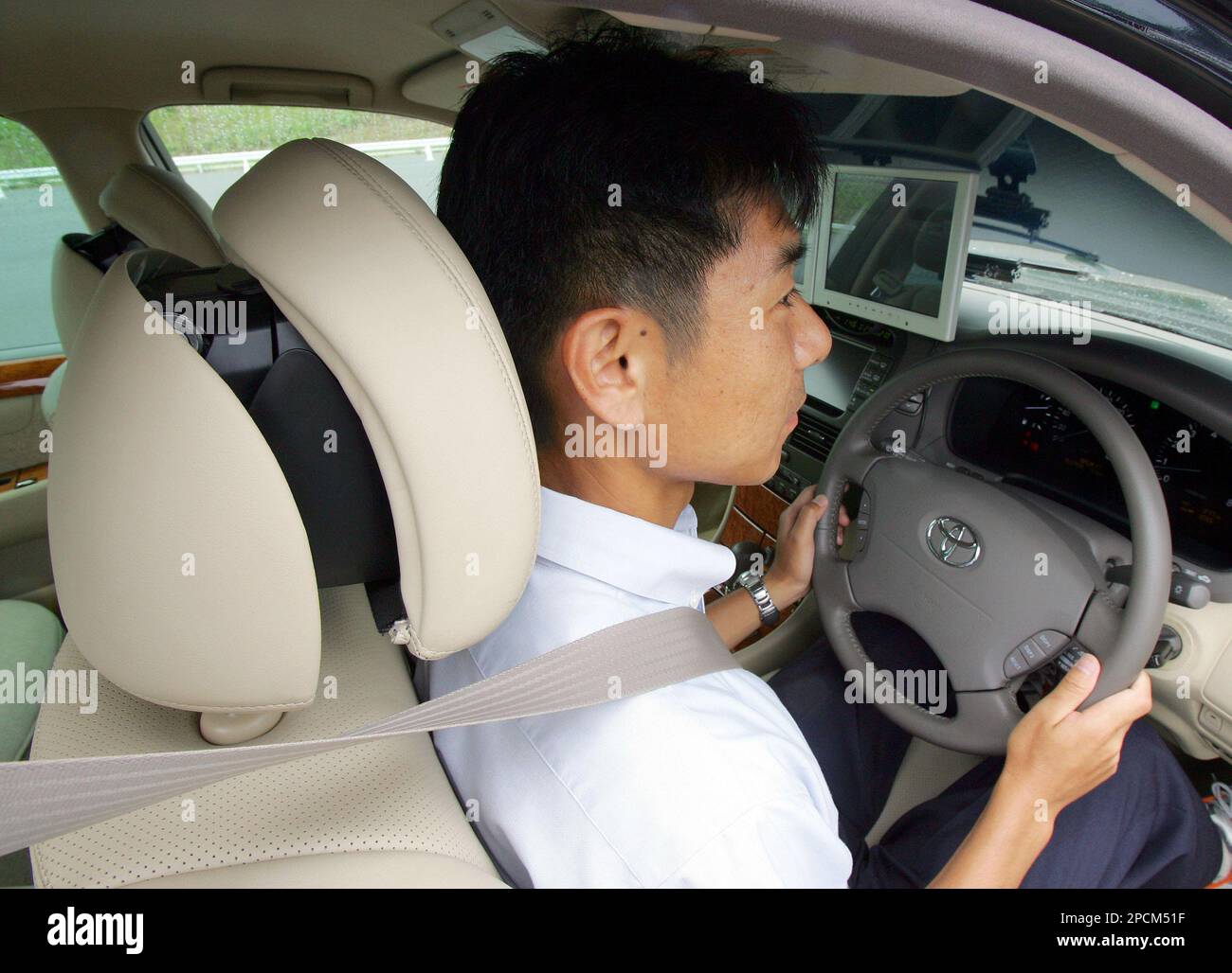 The headrest moves forward to keep a driver's head tightly during a ...