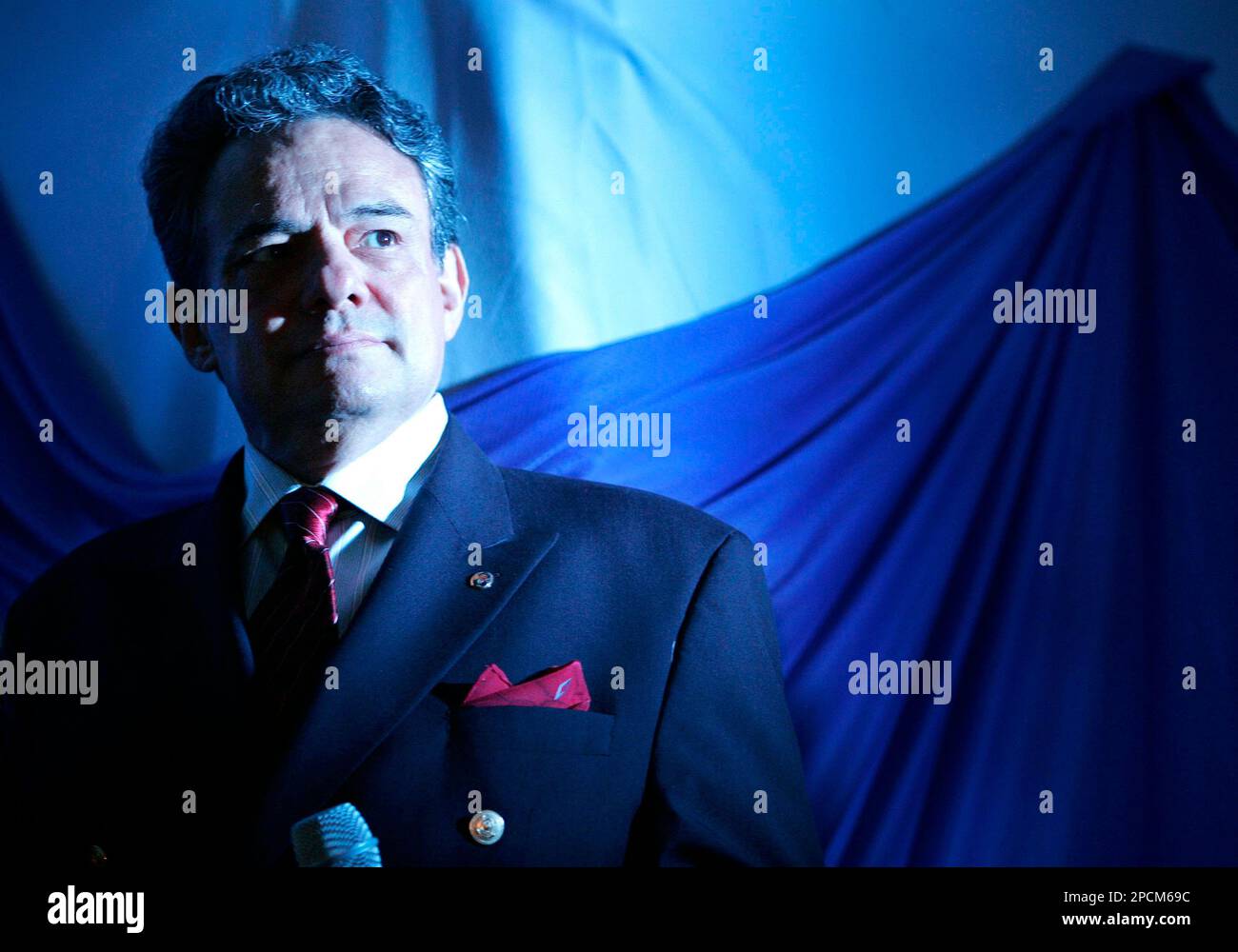 Mexican singer Jose Jose waits under blue stage lights during a visual ...