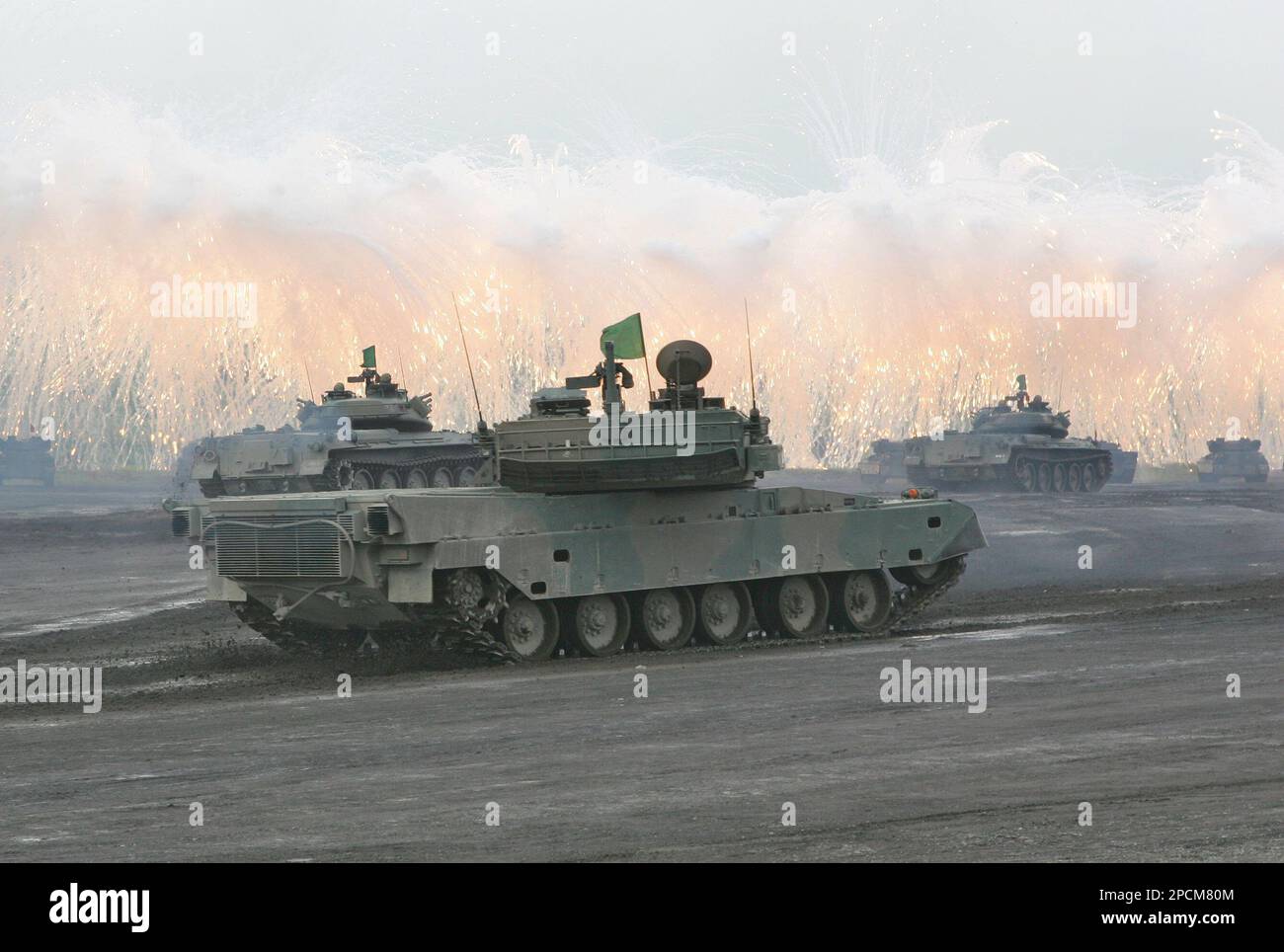 Japan Ground Self-Defense Force tanks roll as smoke screen flares up ...