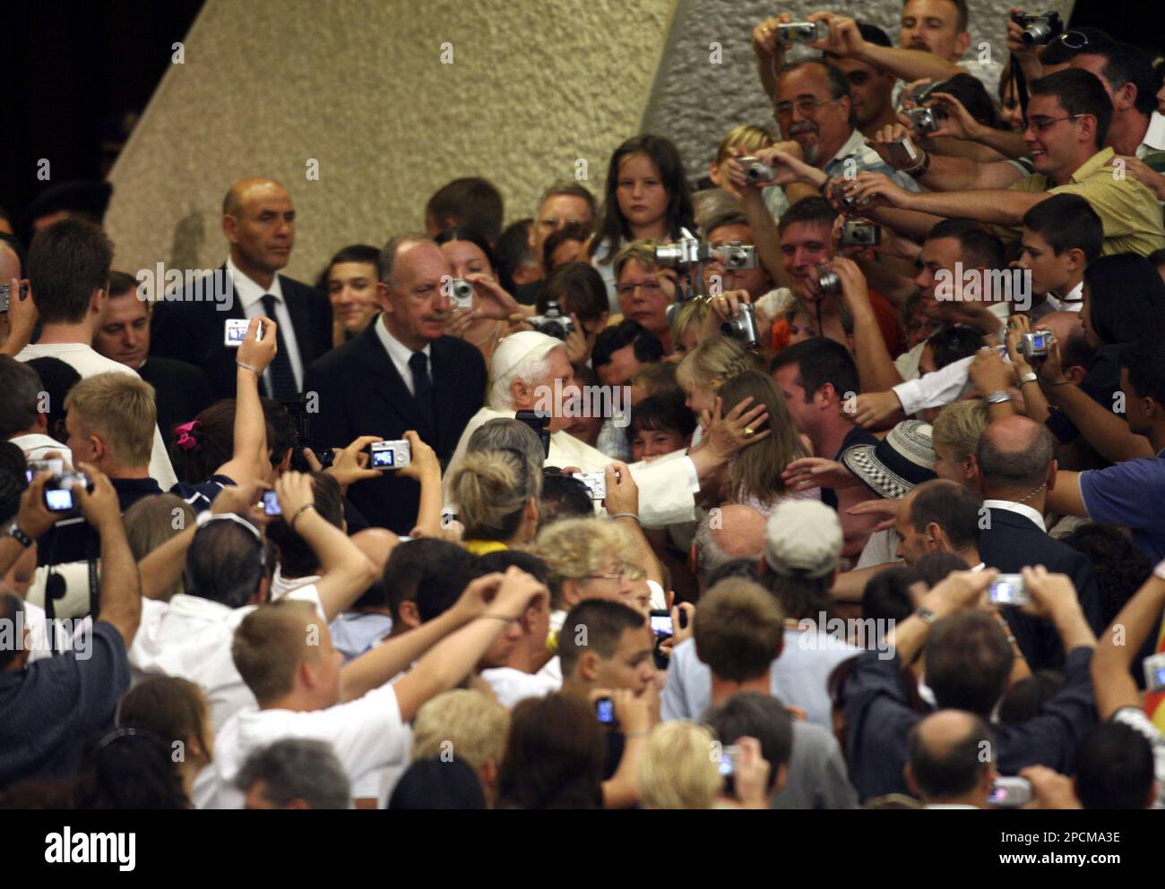 Pope Benedict XVI is cheered by faithful as he arrives for his weekly ...