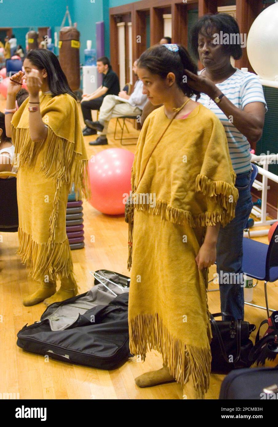 Louise Sebastian combs the hair of her granddaughter, Cheyenne ...