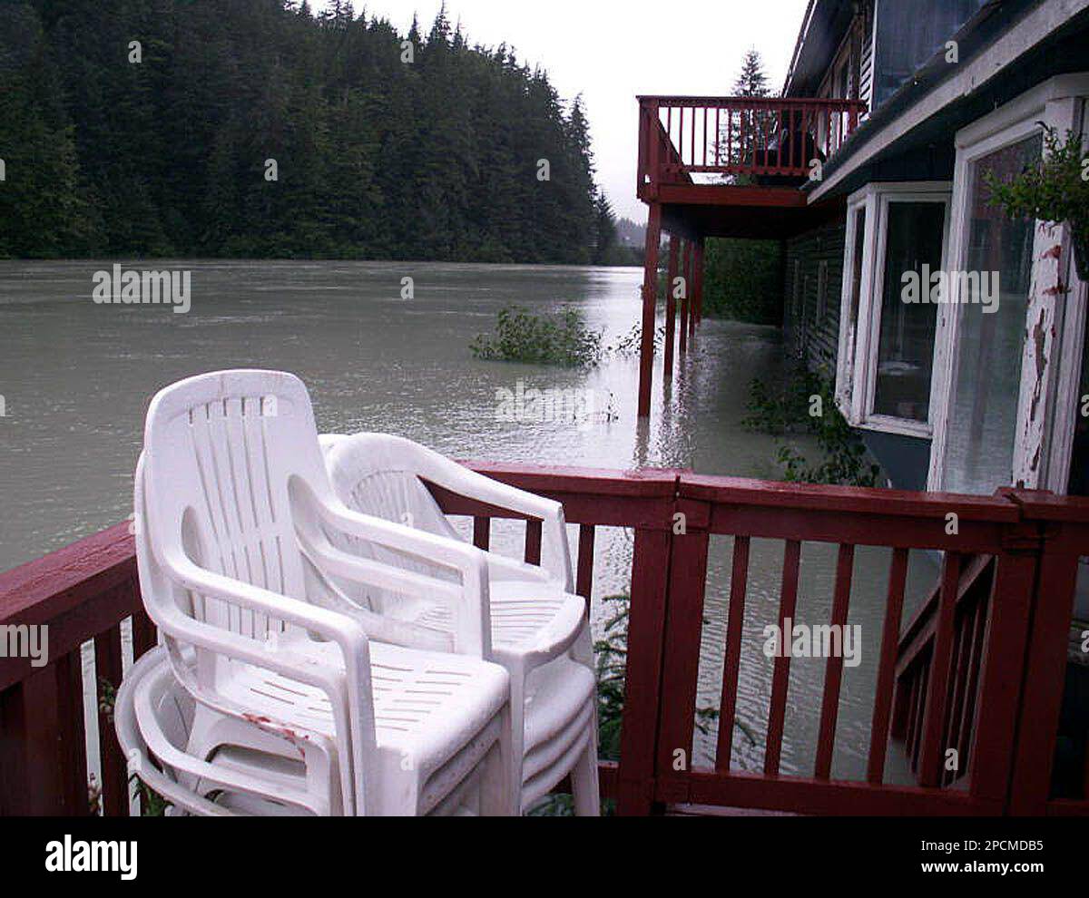 Water rises around a deck on a home alone the Eyak River in Cordova ...