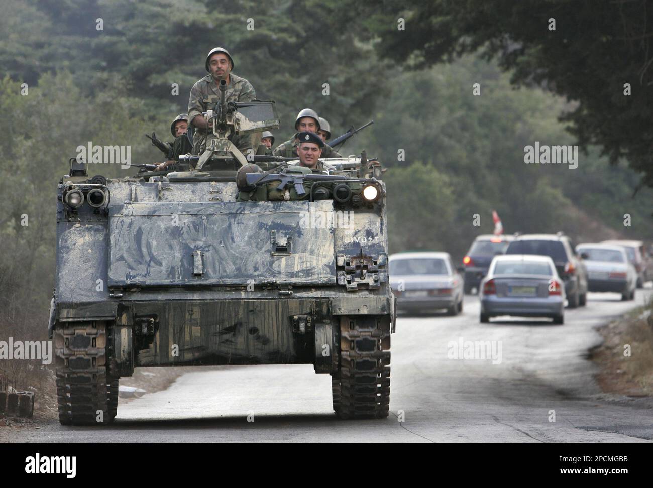 Lebanese soldiers atop an armored personnel carrier move to a new ...