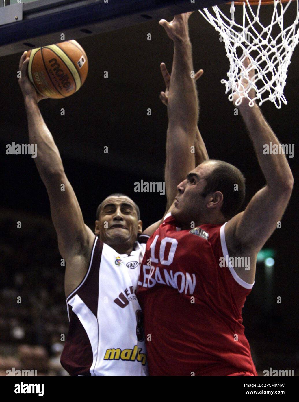 Venezuela's Tomas Aguilera goes for layup by Lebanon's Roy Samaha in ...