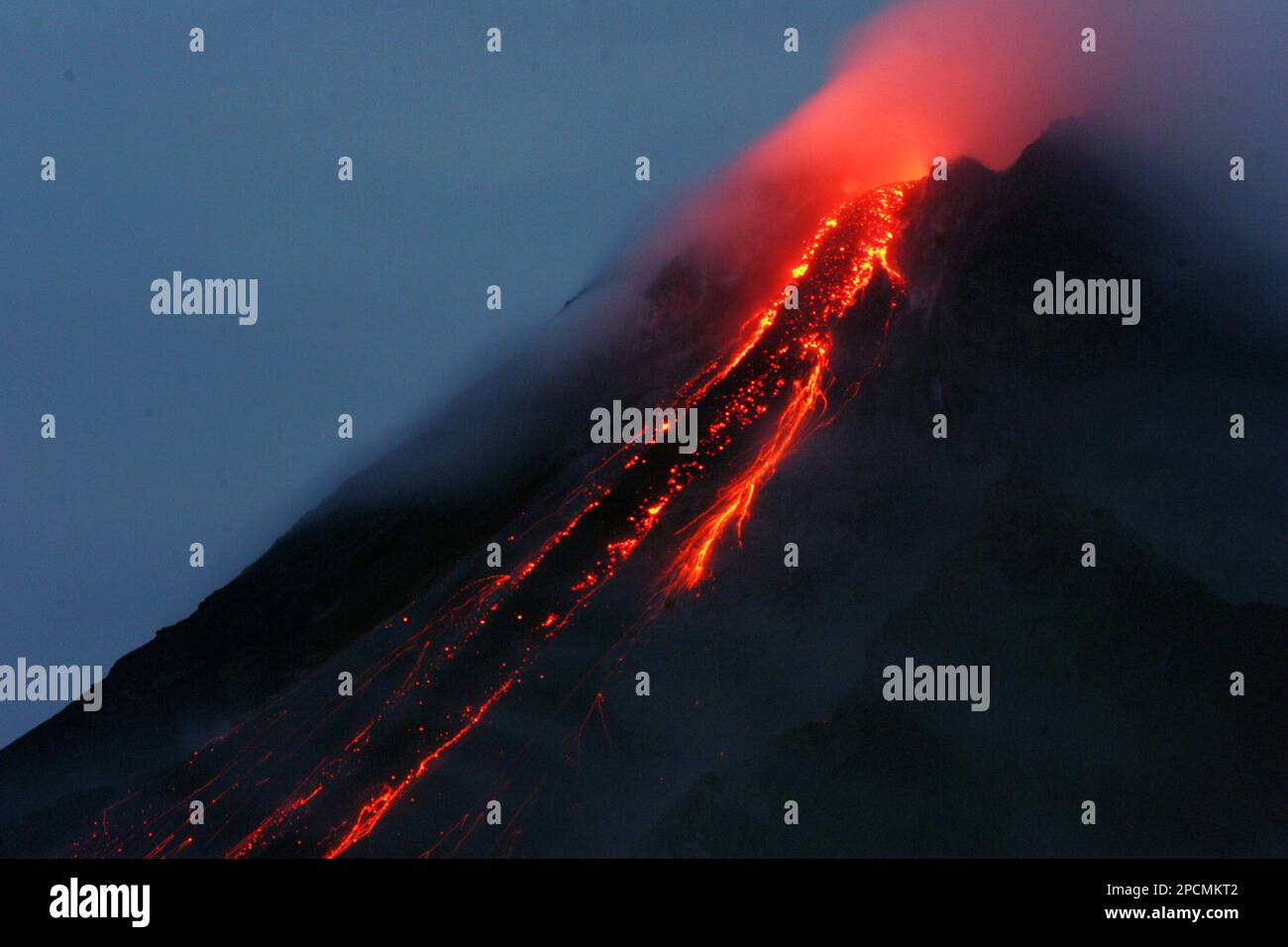 Red hot lava flows down the slopes of Mayon volcano as it continues its ...