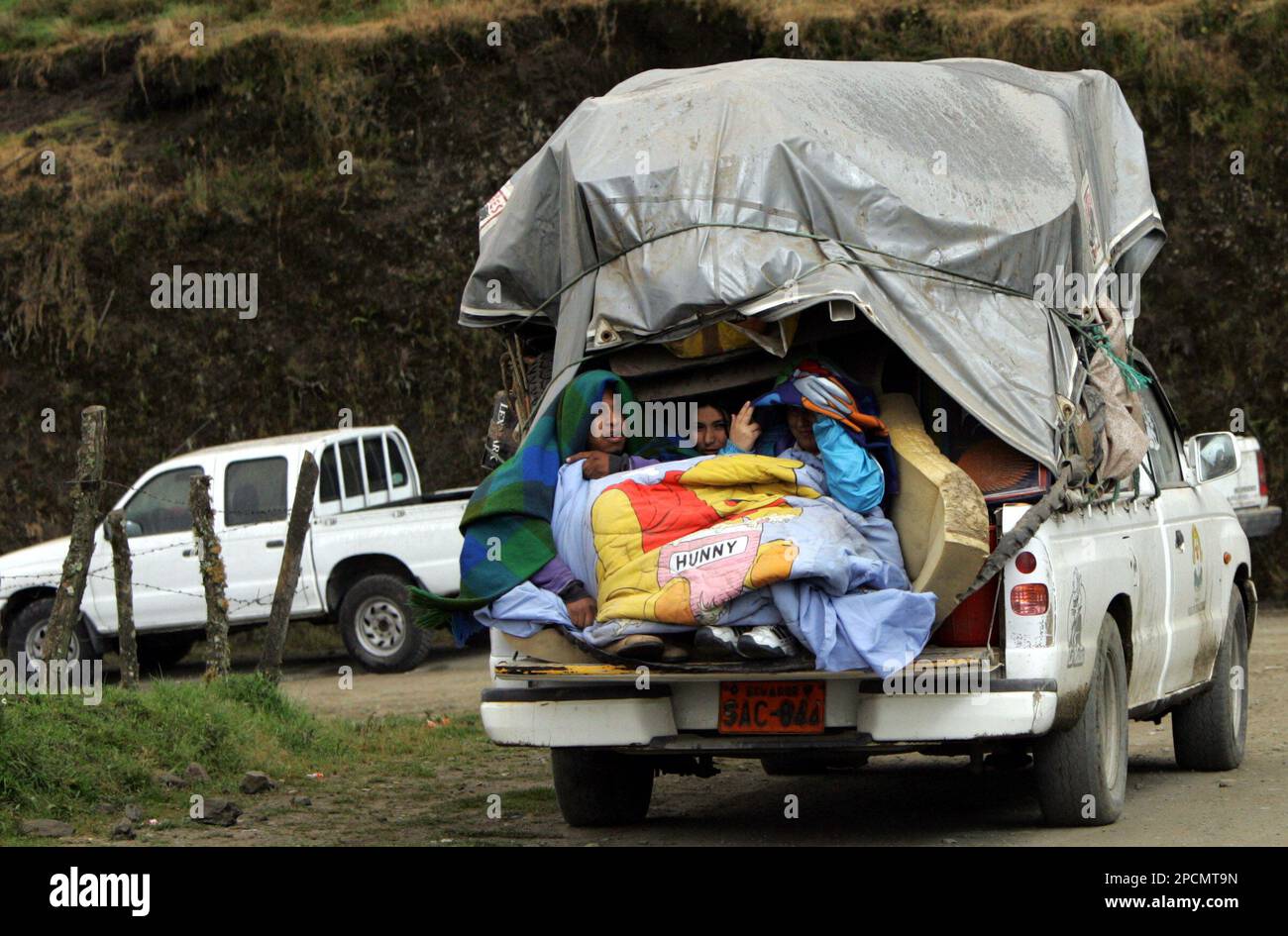 A family evacuates the region of the Tungurahua Volcano Thursday, Aug ...