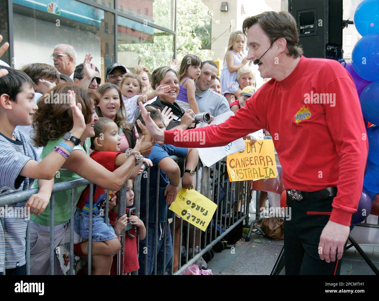 Murray Cook, of the Australian group The Wiggles, high-fives with the ...