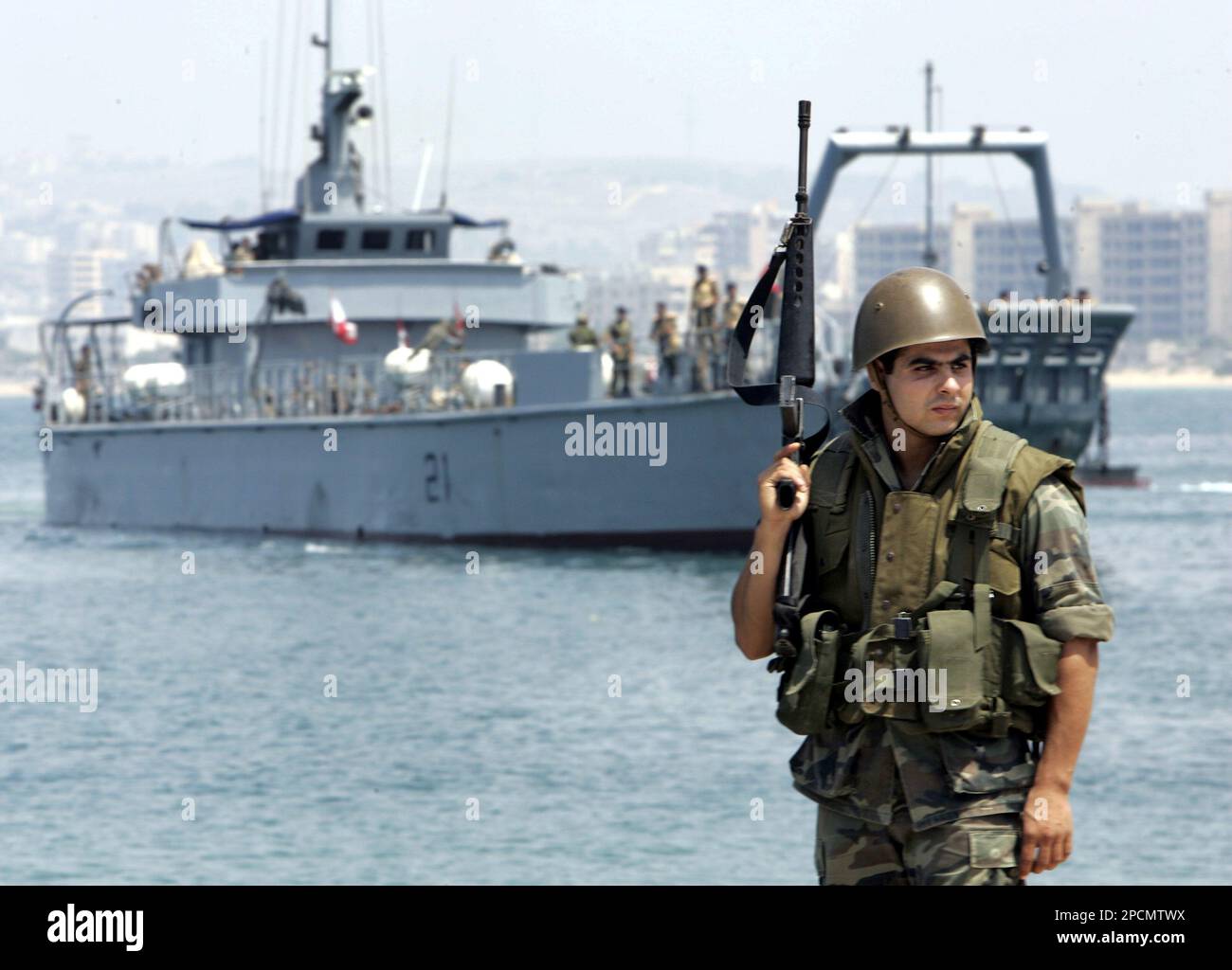 A Lebanese soldier guards the port of the southern city of Tyre ...
