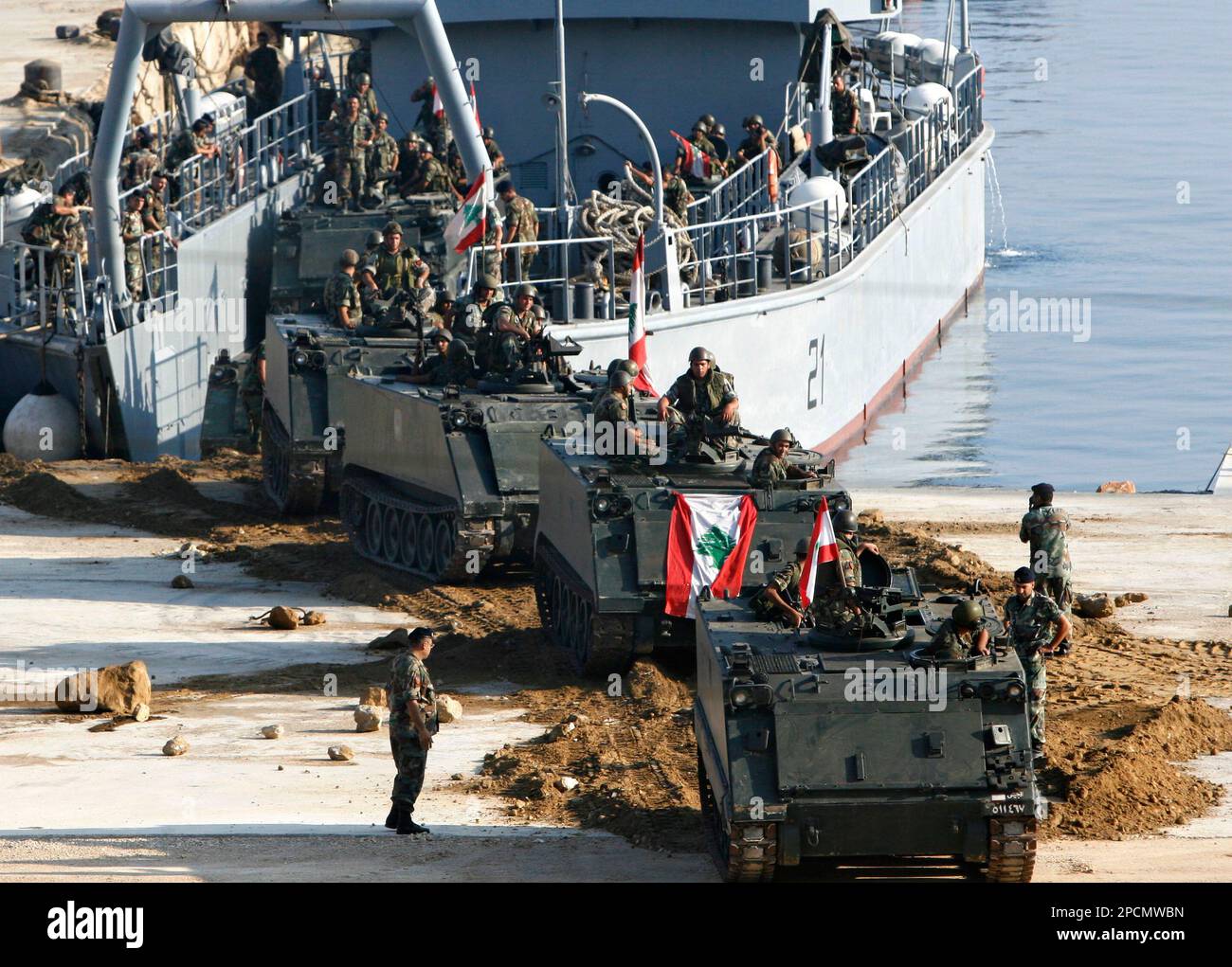 Lebanese troops load army personnel carriers on the deck of a Lebanese ...