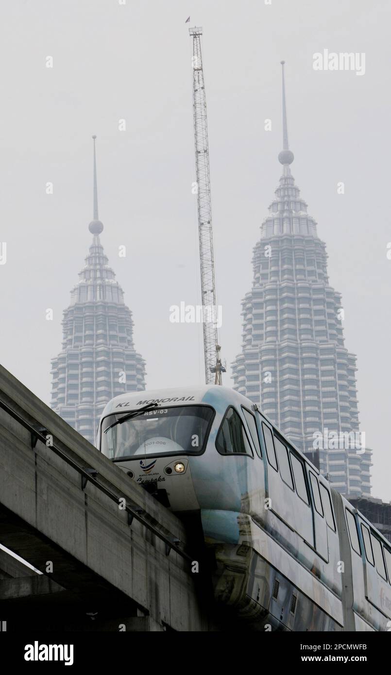 A monorail passes by Petronas Twin Towers in Kuala Lumpur,Thursday, Aug ...