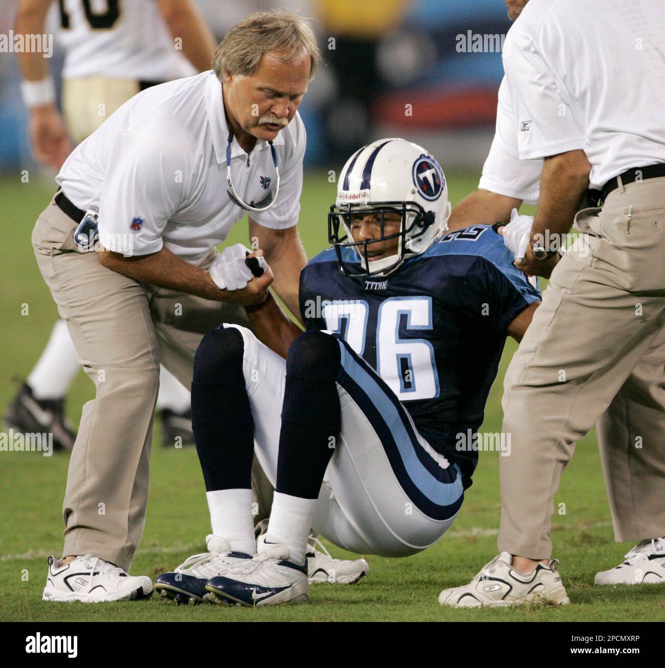 Tennessee Titans cornerback Andre Woolfolk is helped up by team ...