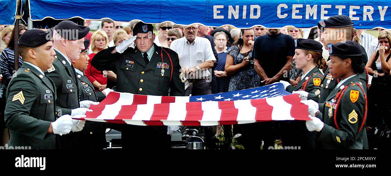 A U.S. Army Honor Guard prepares to fold the flag which draped the ...