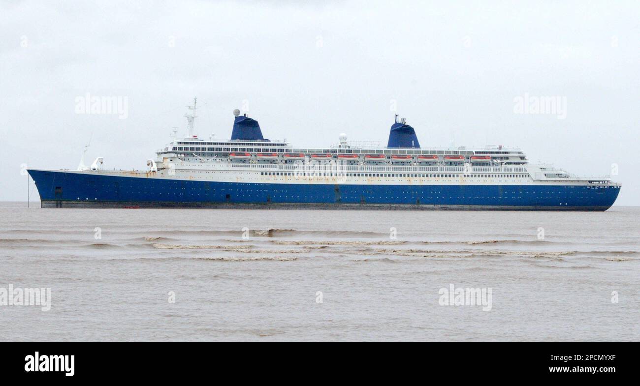 A tugboat pulls ocean liner 'Blue Lady', formerly known as the SS ...