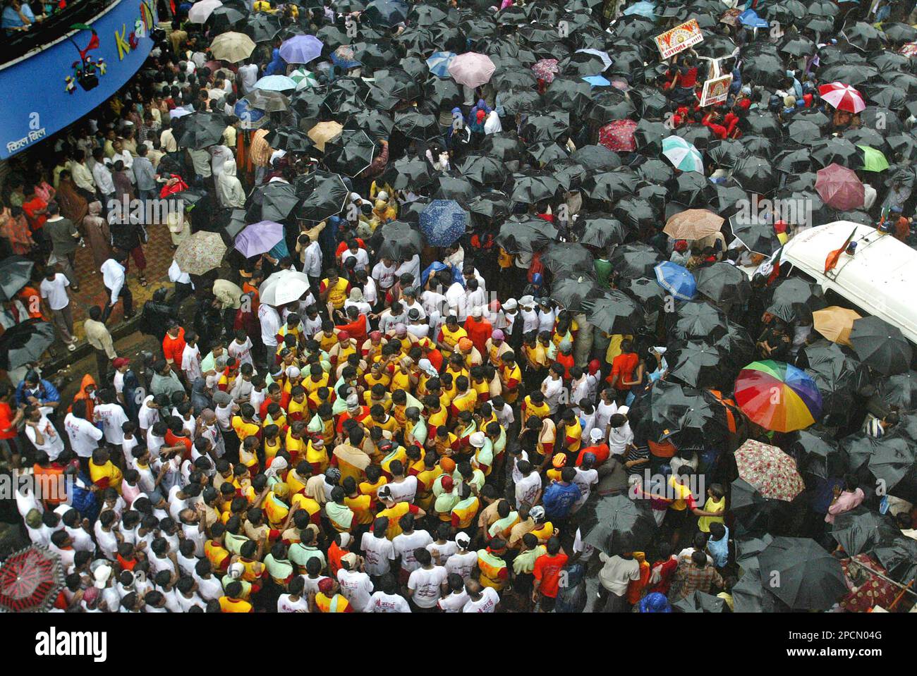 Crowds watch as devotees of Hindu God Krishna make a human pyramid to ...