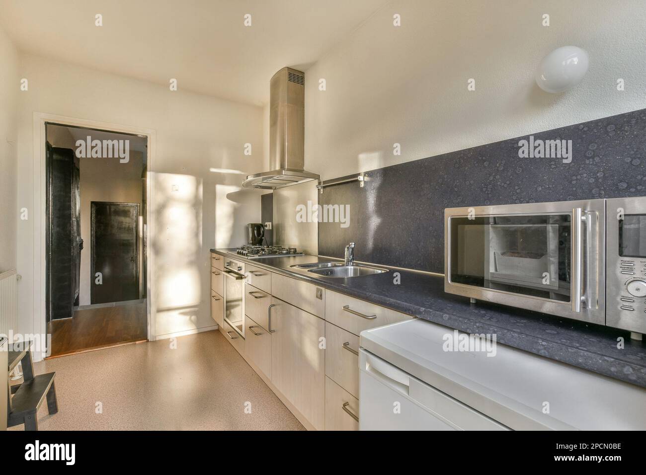 a modern kitchen with white cabinets and stainless appliances on the ...