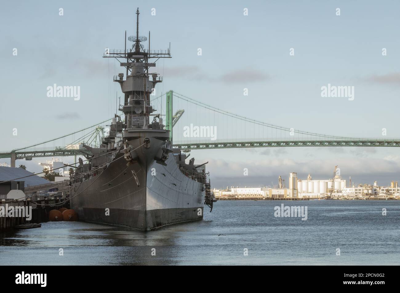 Vintage battleship USS Iowa shown docked. The Vincent Thomas Bridge is ...
