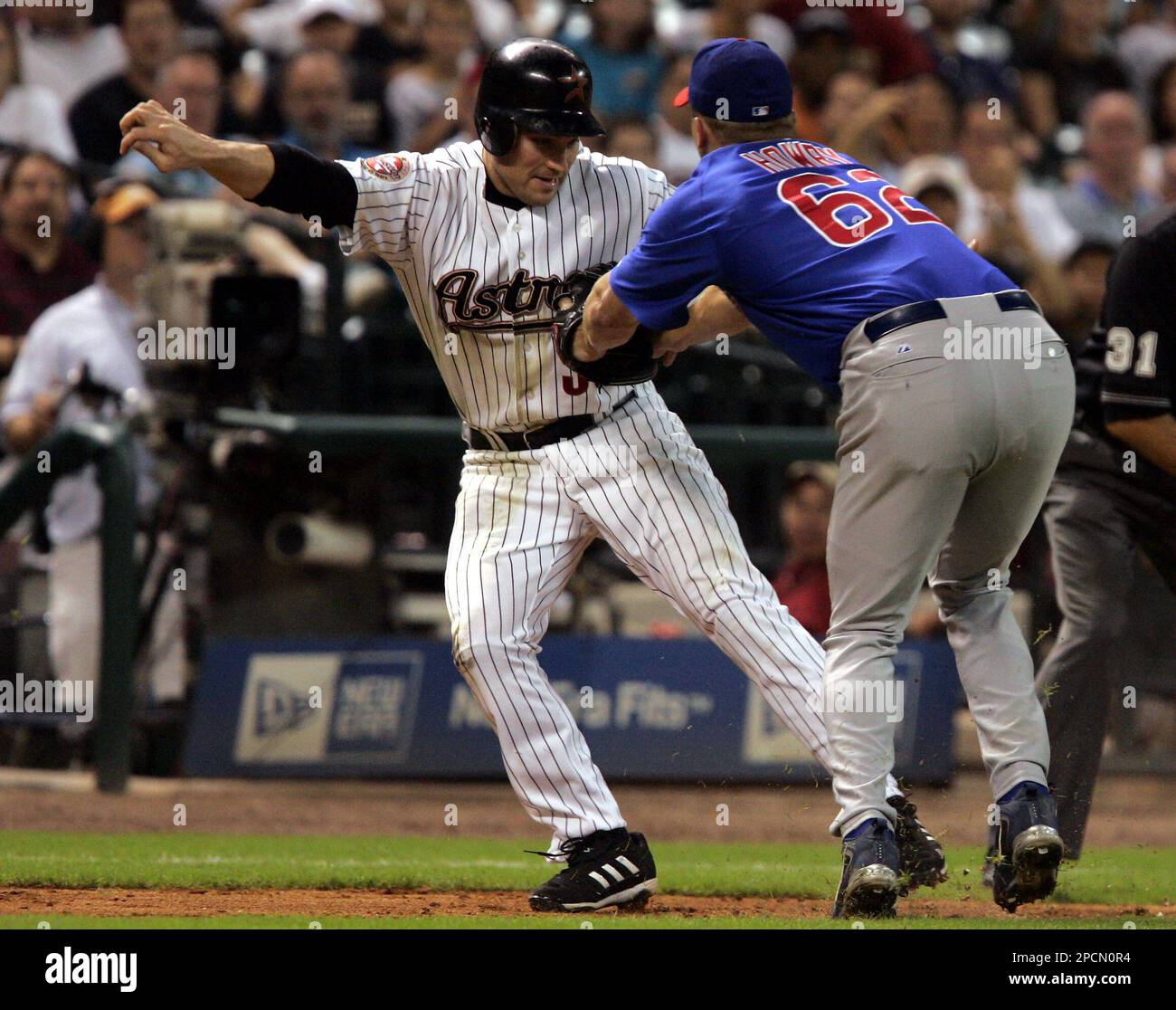 Houston Astros' Luke Scott (30) is tagged out by Chicago Cubs reliever ...