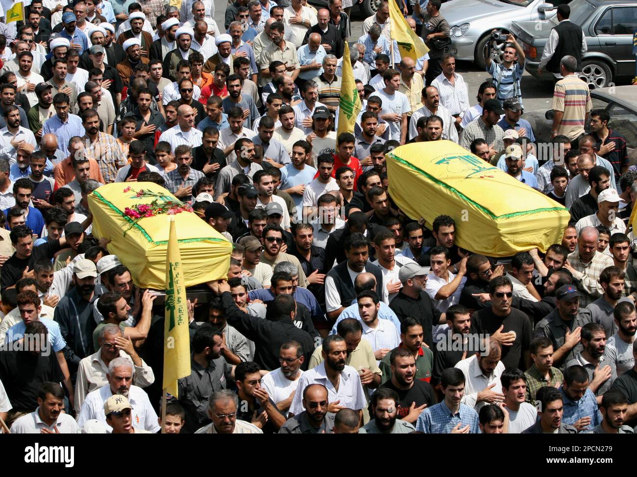 Lebanese mourners carry the coffins of Hezbollah militants Imad al-Hajj ...