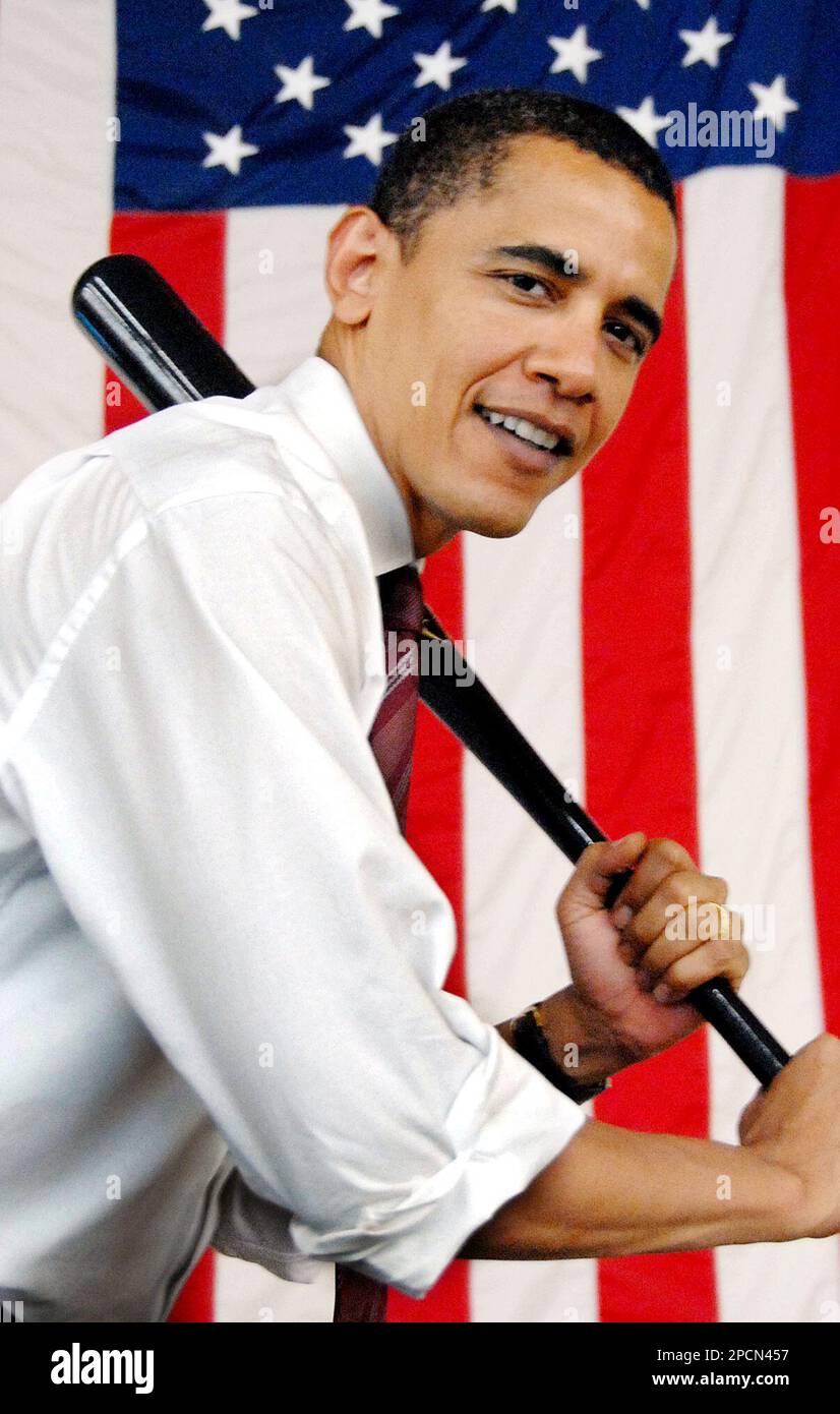 Sen. Barack Obama poses with a baseball bat that he was presented by ...