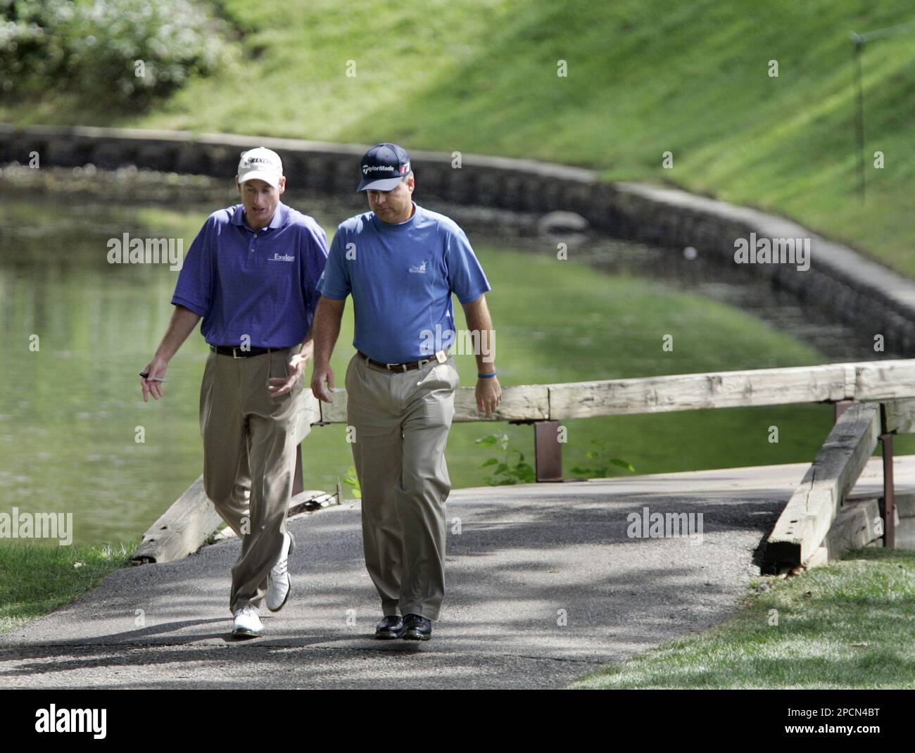 Jim Furyk, left, and Kenny Perry walk to the driving range before their ...