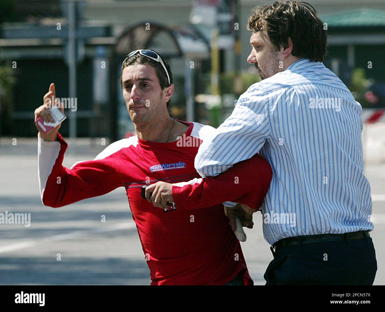 Giuseppe Tempini, left, the boyfriend of Hina Saleem reacts in Brescia ...