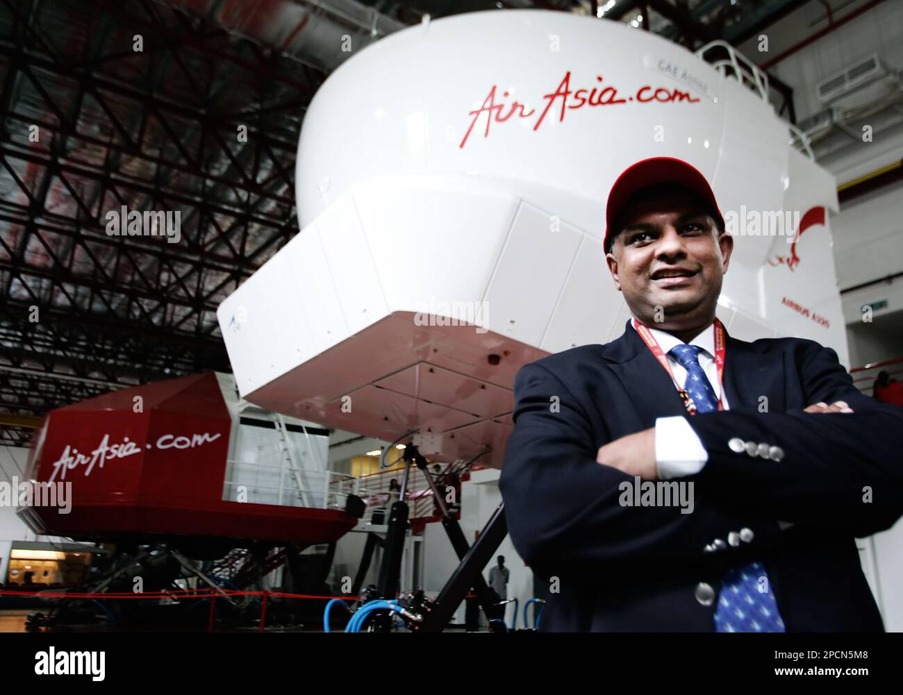 Tony Fernandes, CEO of AirAsia pose in-front of the Airbus 320, white ...