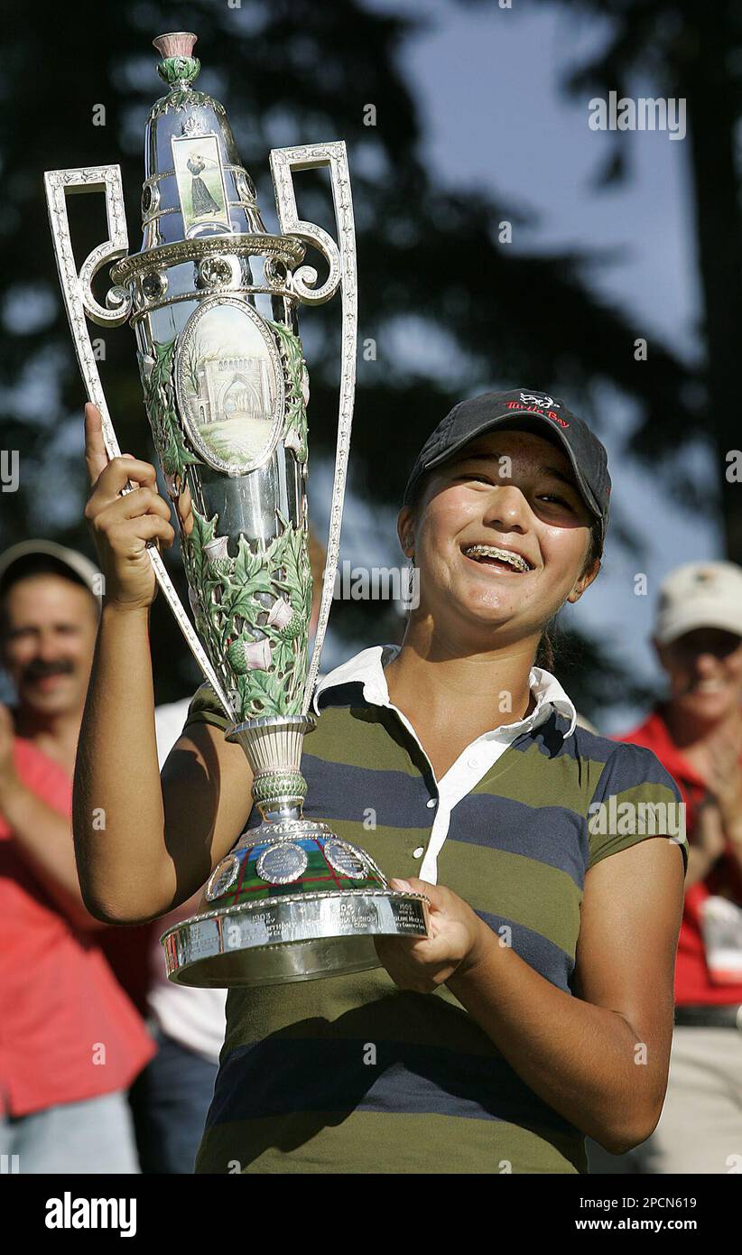 Kimberly Kim, from Hilo, Hi., holds up her trophy after winning the ...