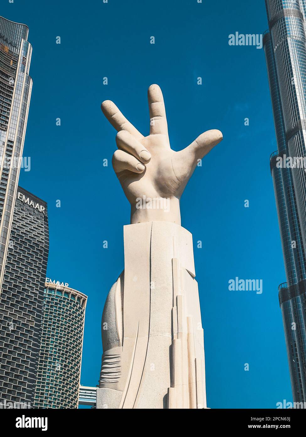 Three Fingers Statue in Burj Park surrounded by skyscrapers in Downtown ...