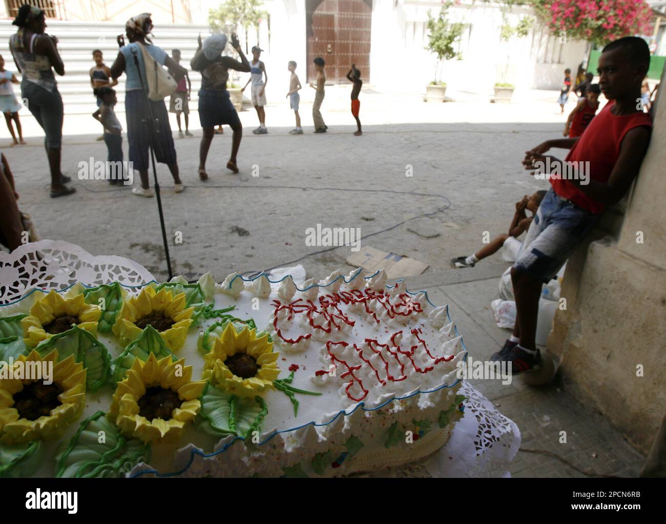 Children play next to birthday cake that reads "Always with you Fidel ...